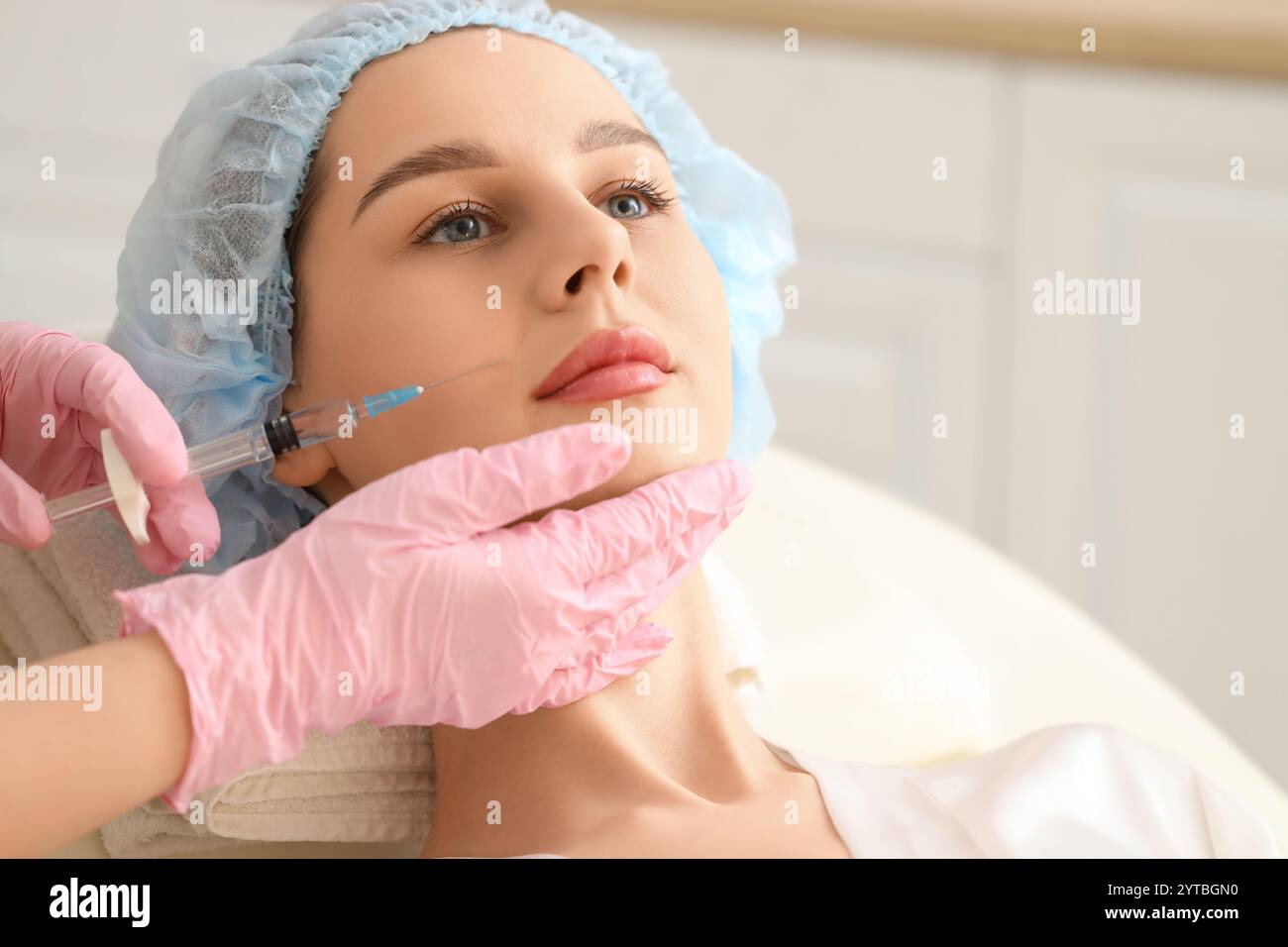 Young girl receiving filler injection in beauty salon Stock Photo - Alamy