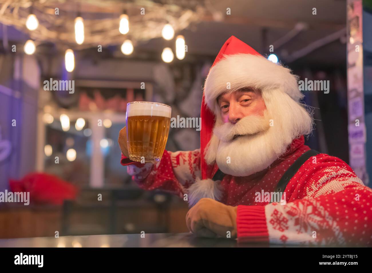 Santa Claus drinking beer at a bar Stock Photo - Alamy