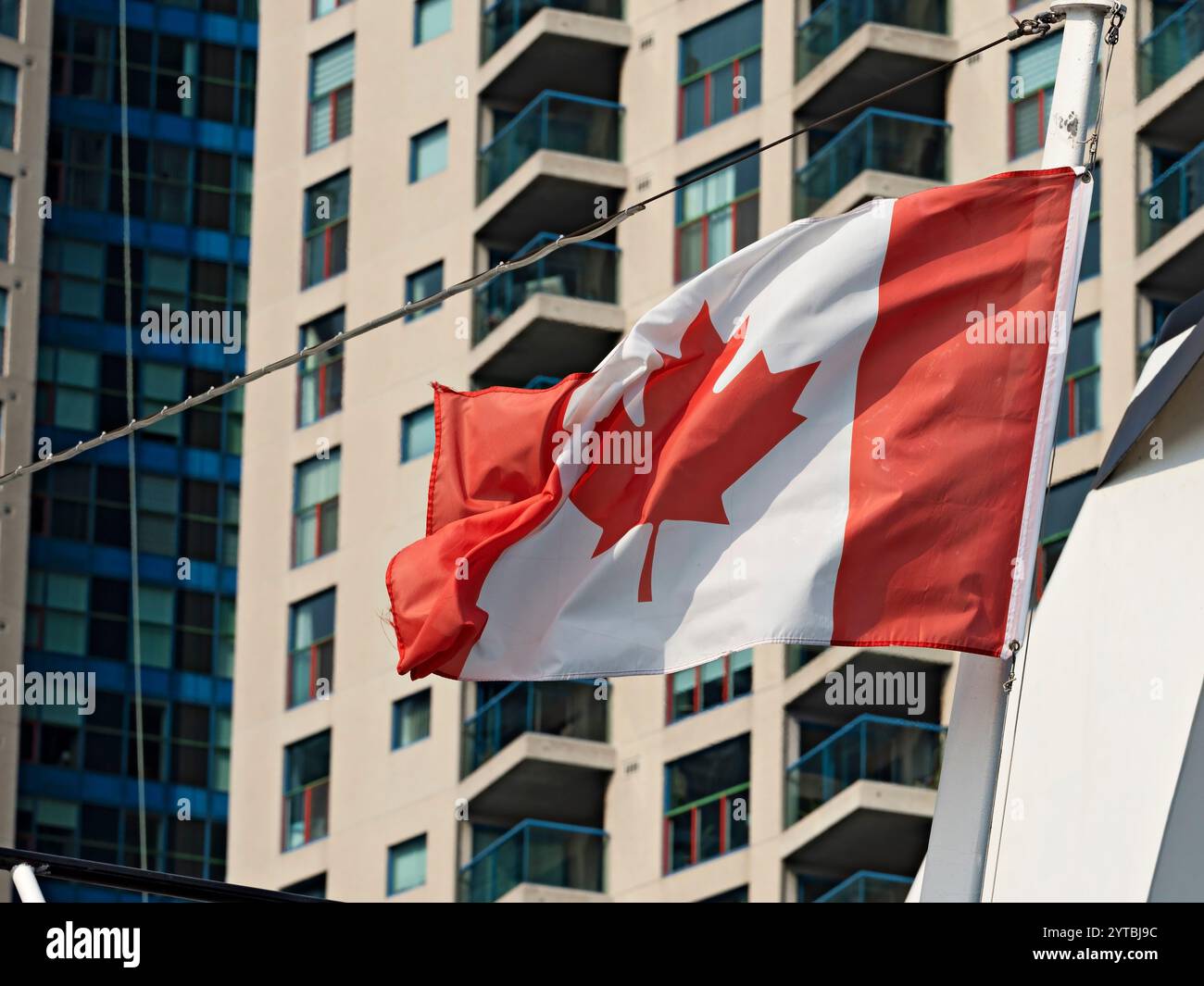 Toronto Canada / A Canadian National Flag flutters in the breeze atop a ...