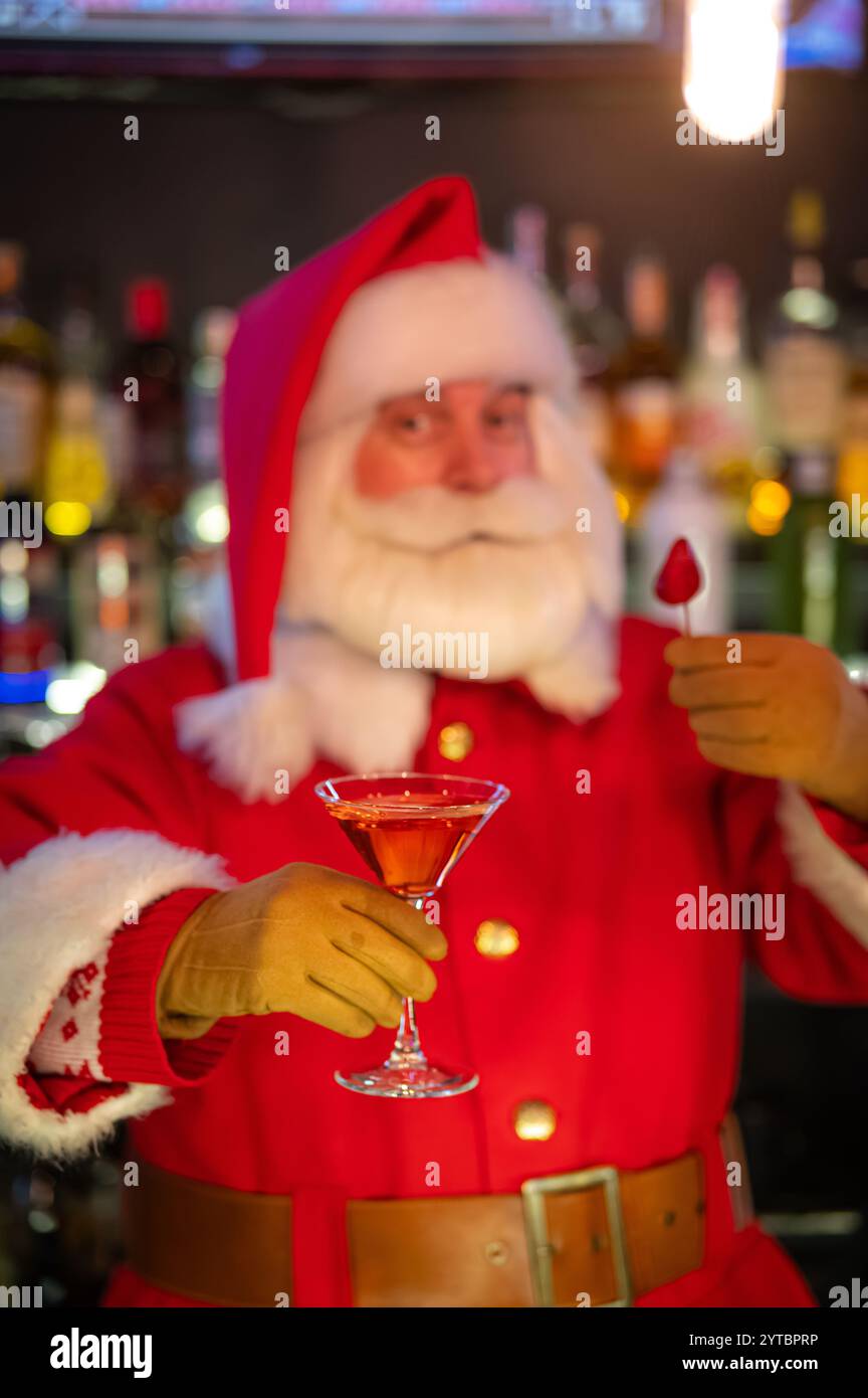 Santa Claus drinking a cocktail at a bar Stock Photo - Alamy