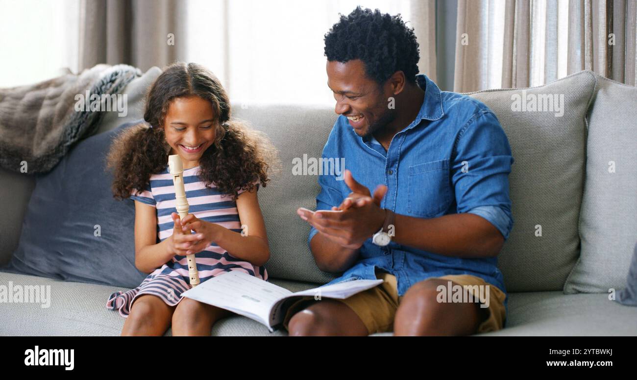 Learning, music and kid with father for flute lesson on sofa with book ...