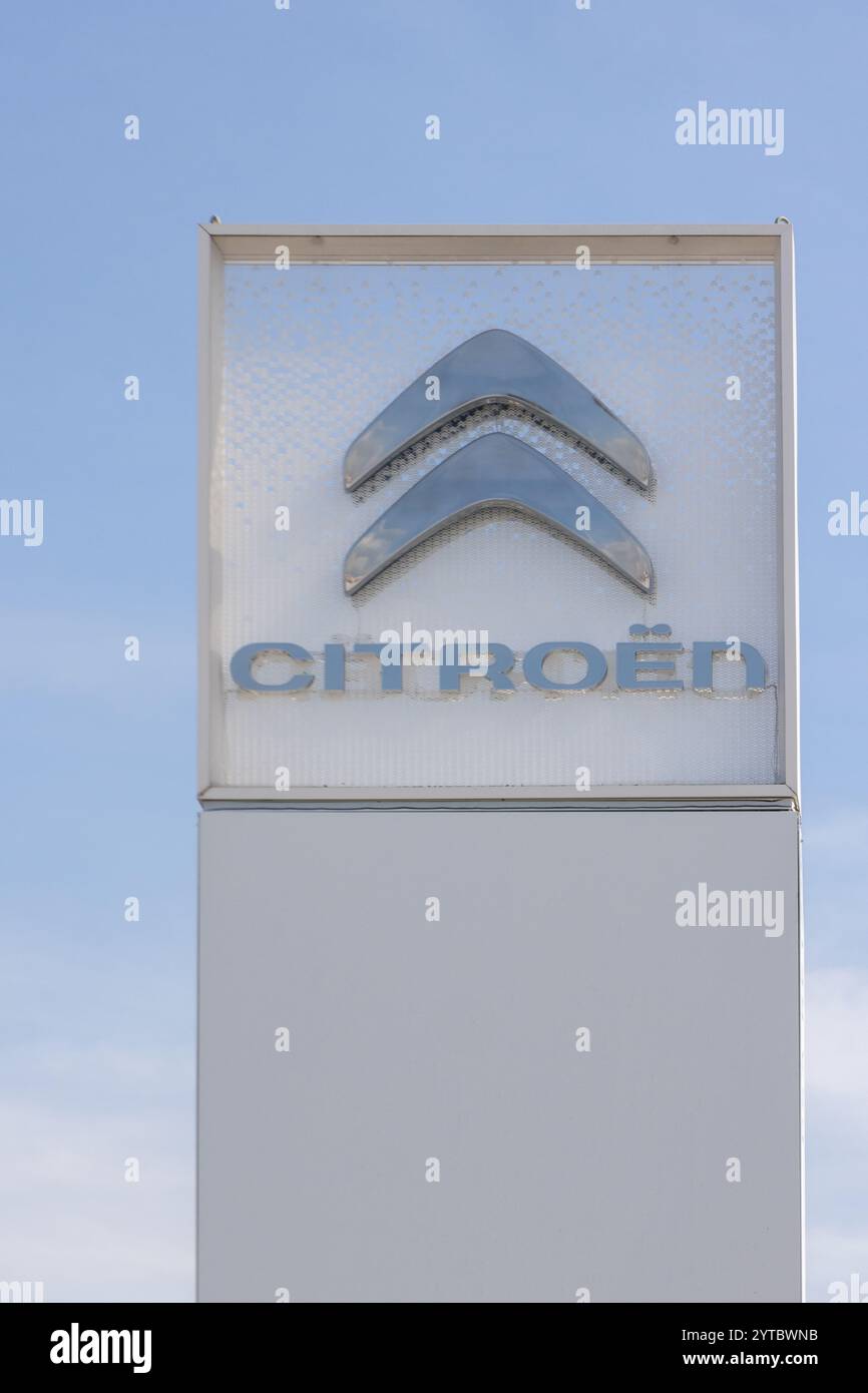 Citroen logo displayed on a dealership sign with a clear blue sky ...