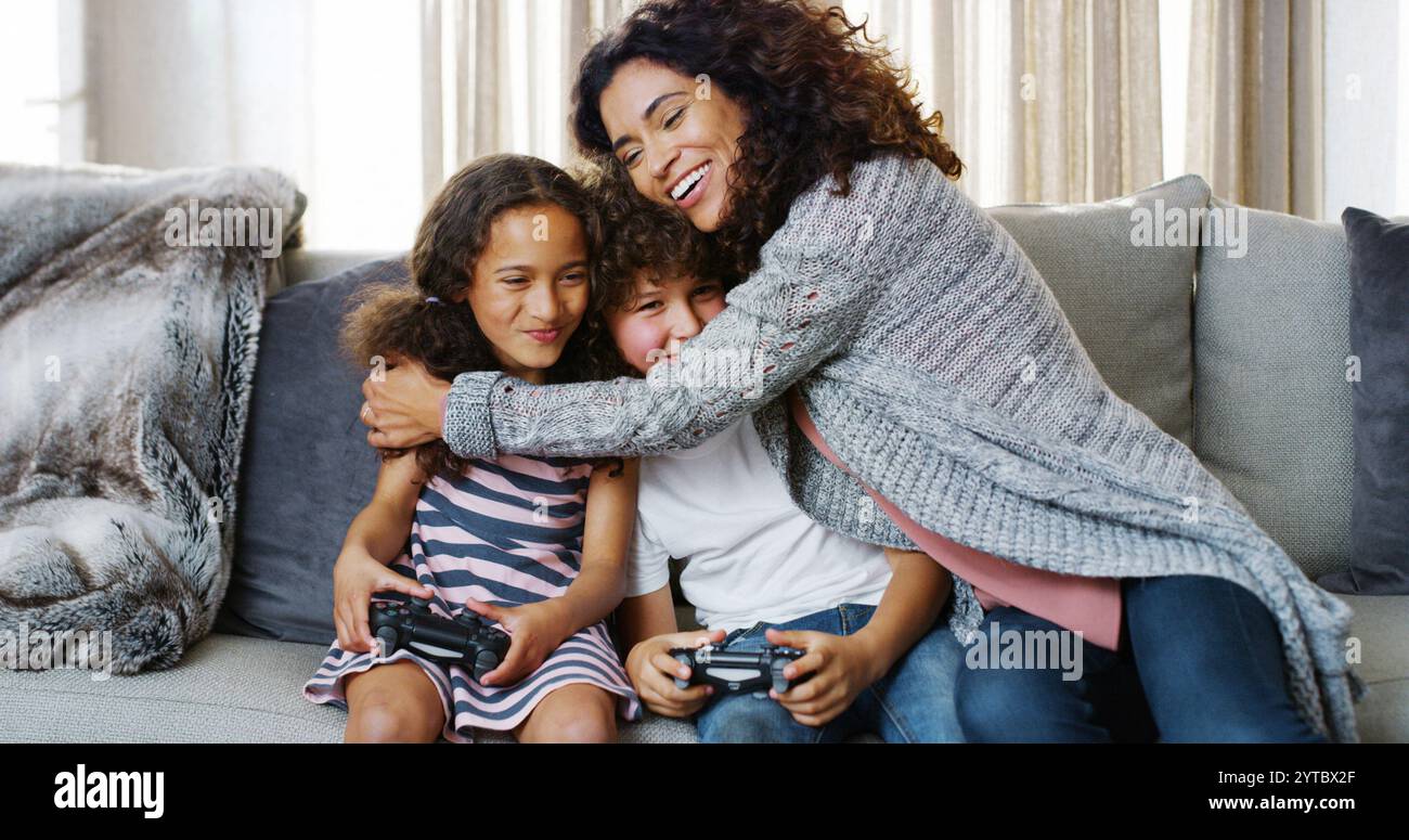 Kids, family home and video game with mom, hug and bonding together in ...