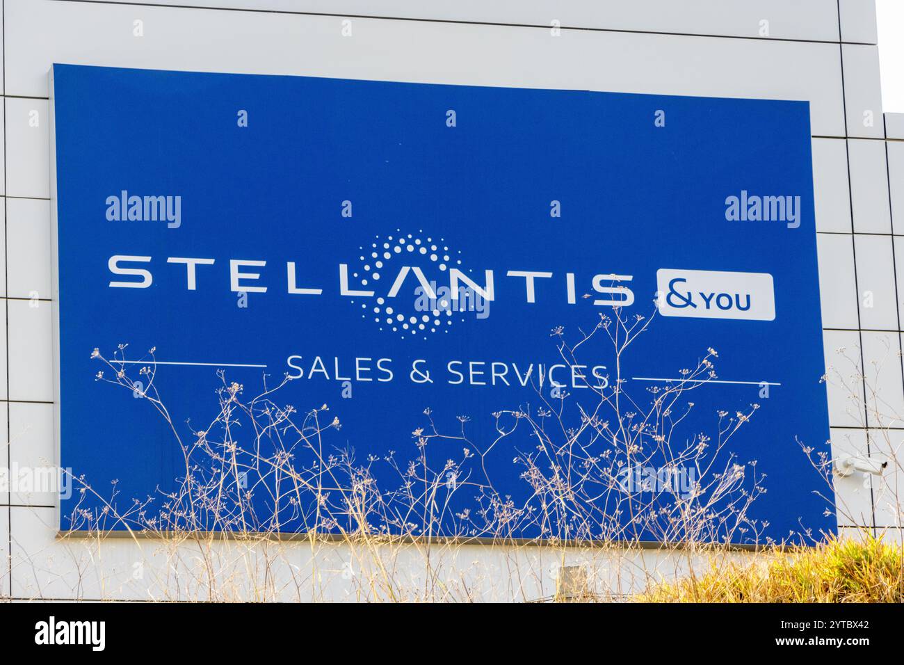 Large blue stellantis sign featuring company logo and sales and ...