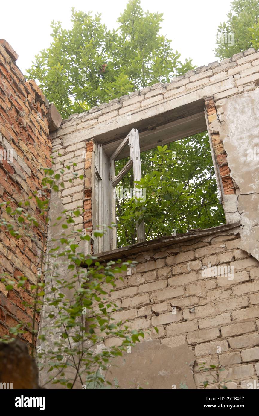 A broken, empty window of building ruins from Soviet times. Collapsed ...
