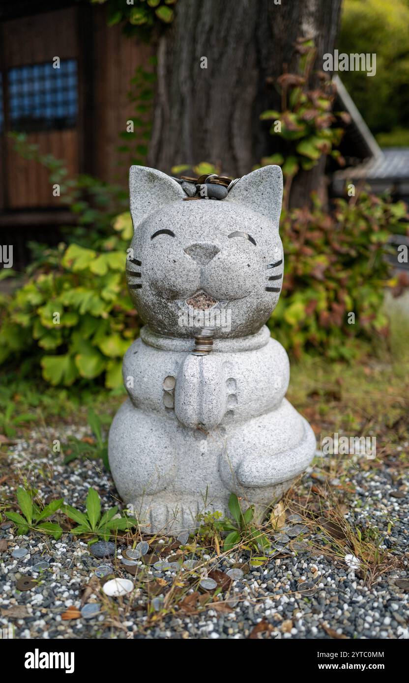 A smiling cat statue at a shrine on the island of Naoshima Japan Stock ...
