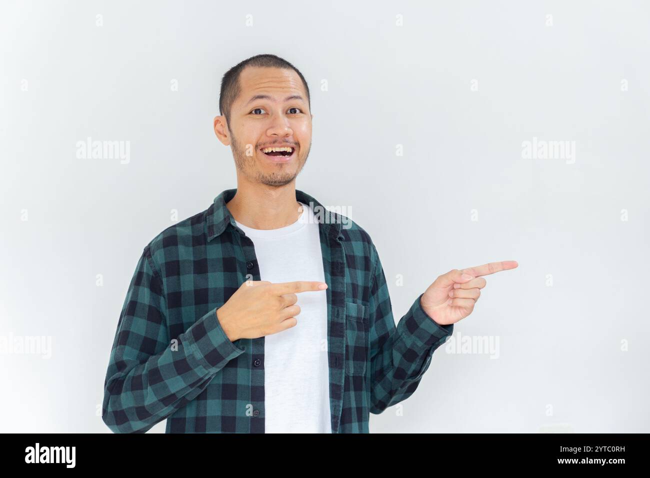 Young Adult Asian men wearing flannel and shirt pointing finger to the ...