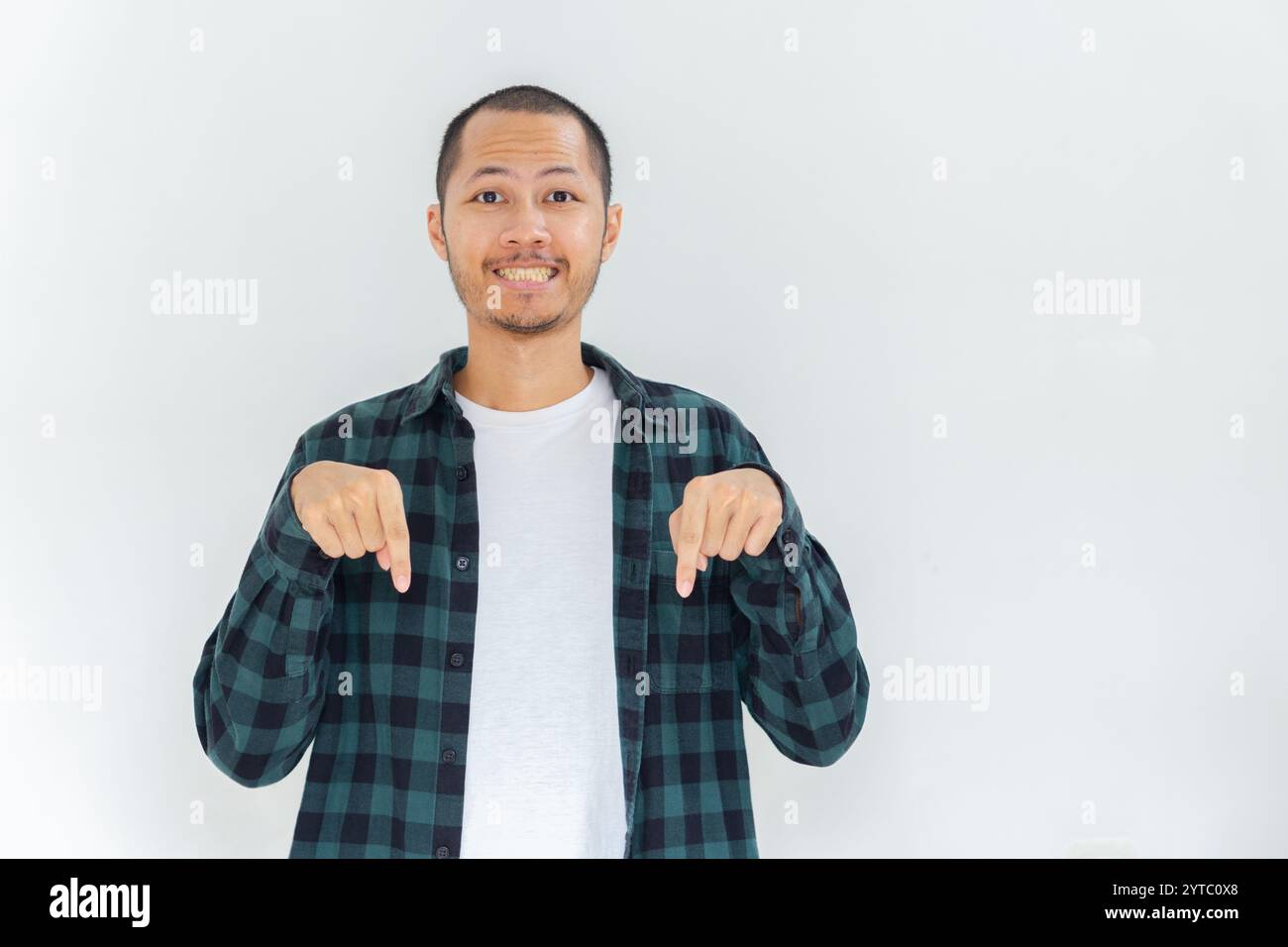 Young Adult Asian men wearing flannel and shirt pointing finger down ...