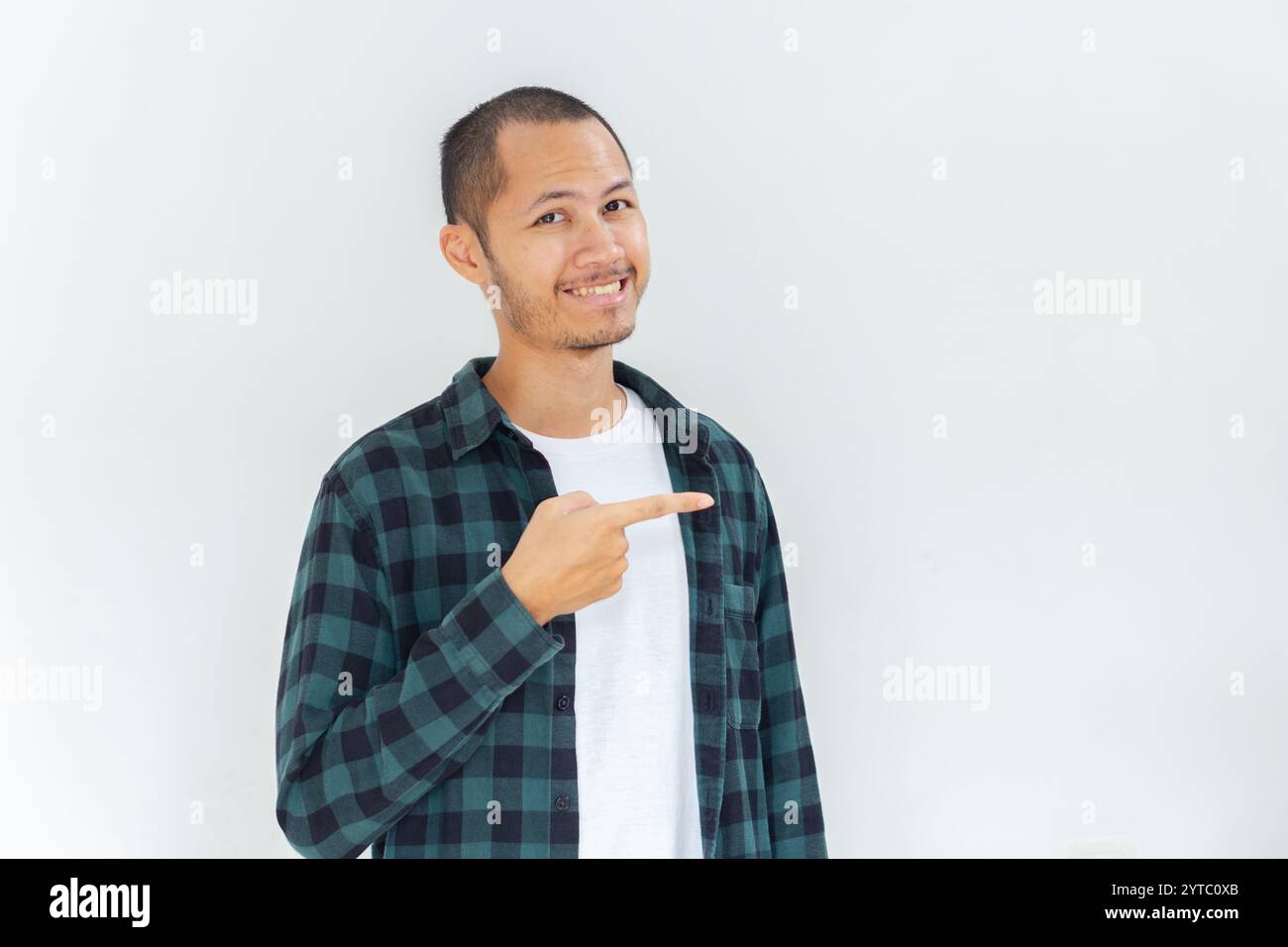 Young Adult Asian men wearing flannel and shirt pointing finger to the ...