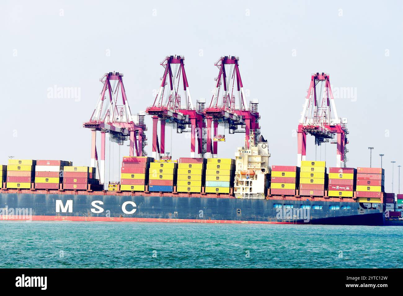 QINGDAO, CHINA - DECEMBER 7, 2024 - Cargo ships load and unload ...