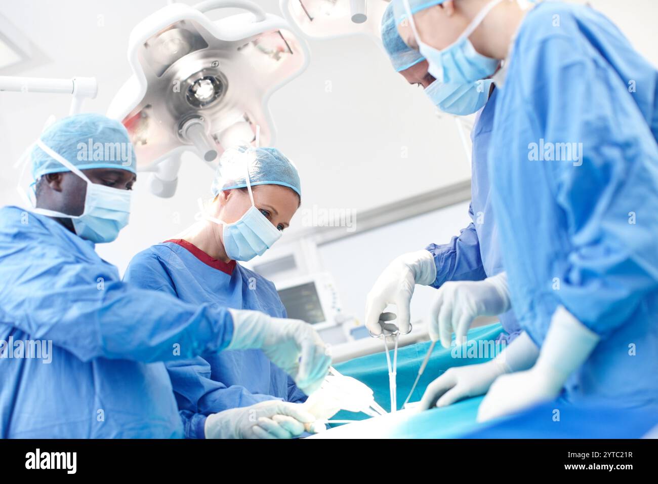 Surgery, team and doctors in theater together for emergency medical treatment in hospital ppe ...