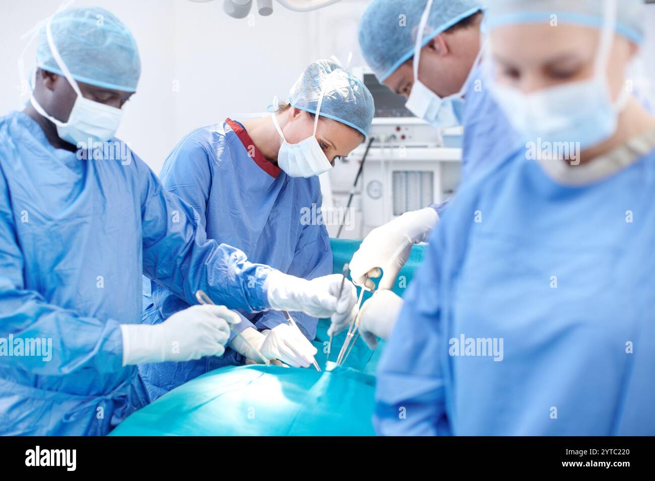 Surgery, teamwork and doctors in operating room together for emergency ...