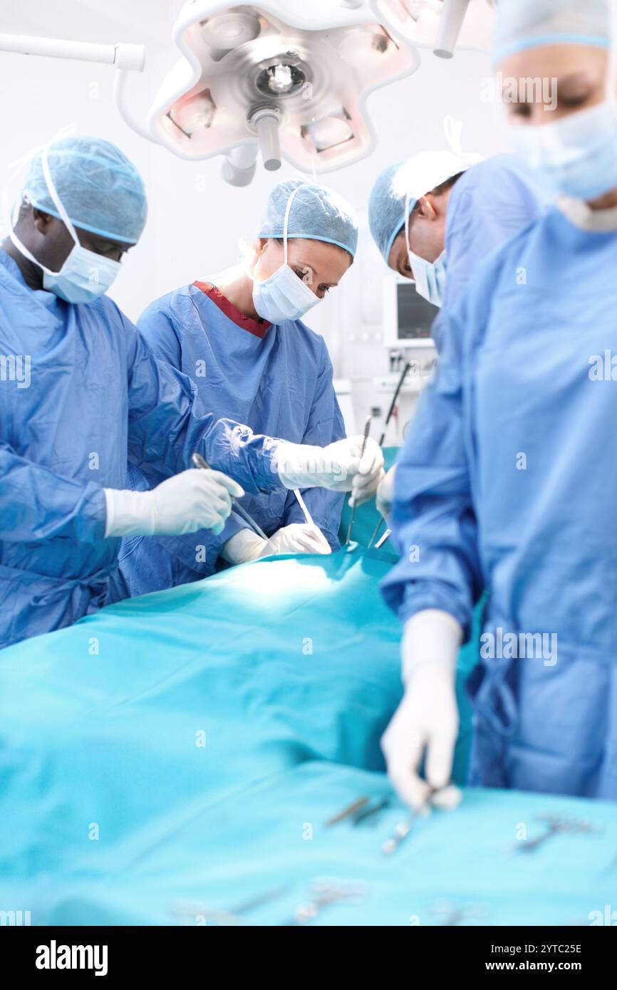 Surgery, teamwork and doctors in theater with tools in emergency medical treatment at hospital ...