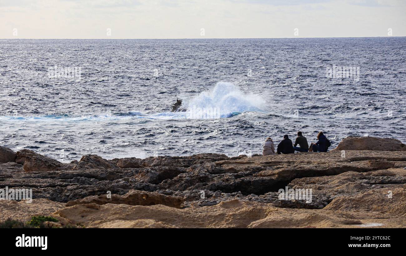People watching waves breaking at Dwejra Bay, Gozo, Malta Stock Photo ...