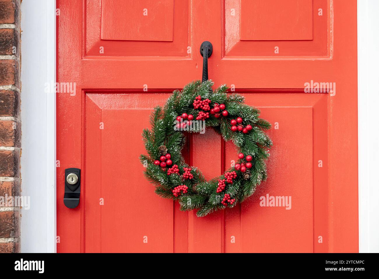 Traditional Christmas holly wreath on a door in England. December 2024 ...