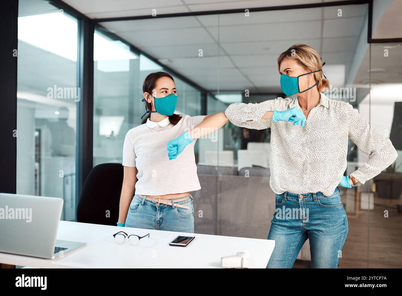 Women, mask and elbow greeting in office for covid safety, compliance ...