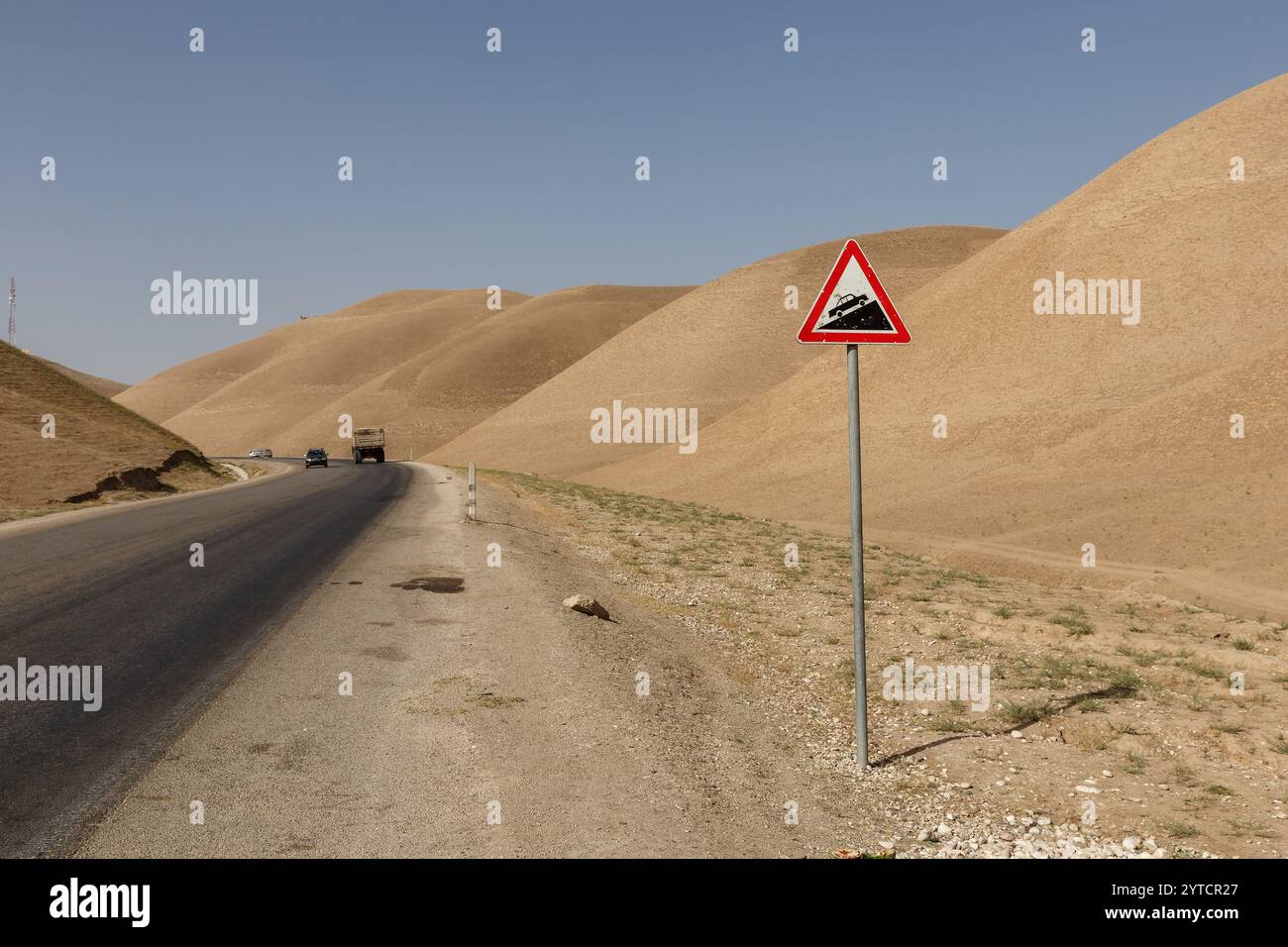 Afghan Desert Road with Warning Sign and Rolling Hills, Faryab Province ...