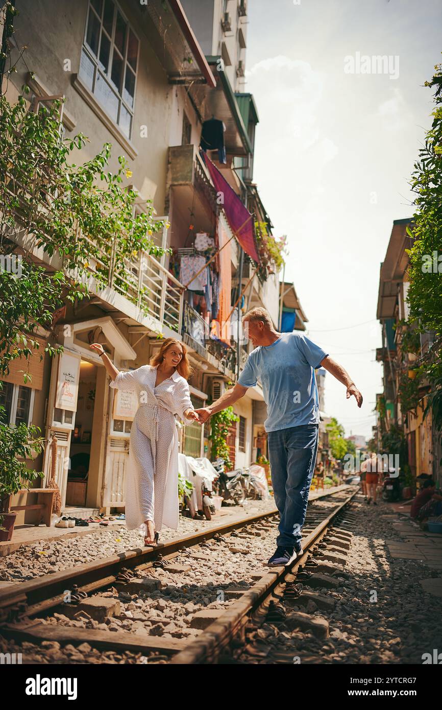 Travel, love and couple holding hands on railway track for holiday ...