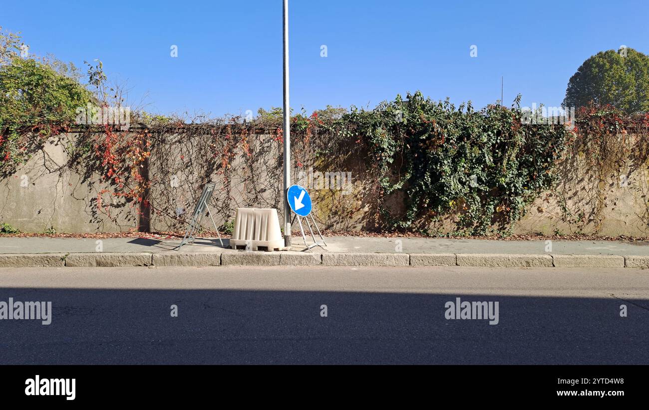 Roadworks Front view Mandatory left turn sign on pavement Italy Stock ...