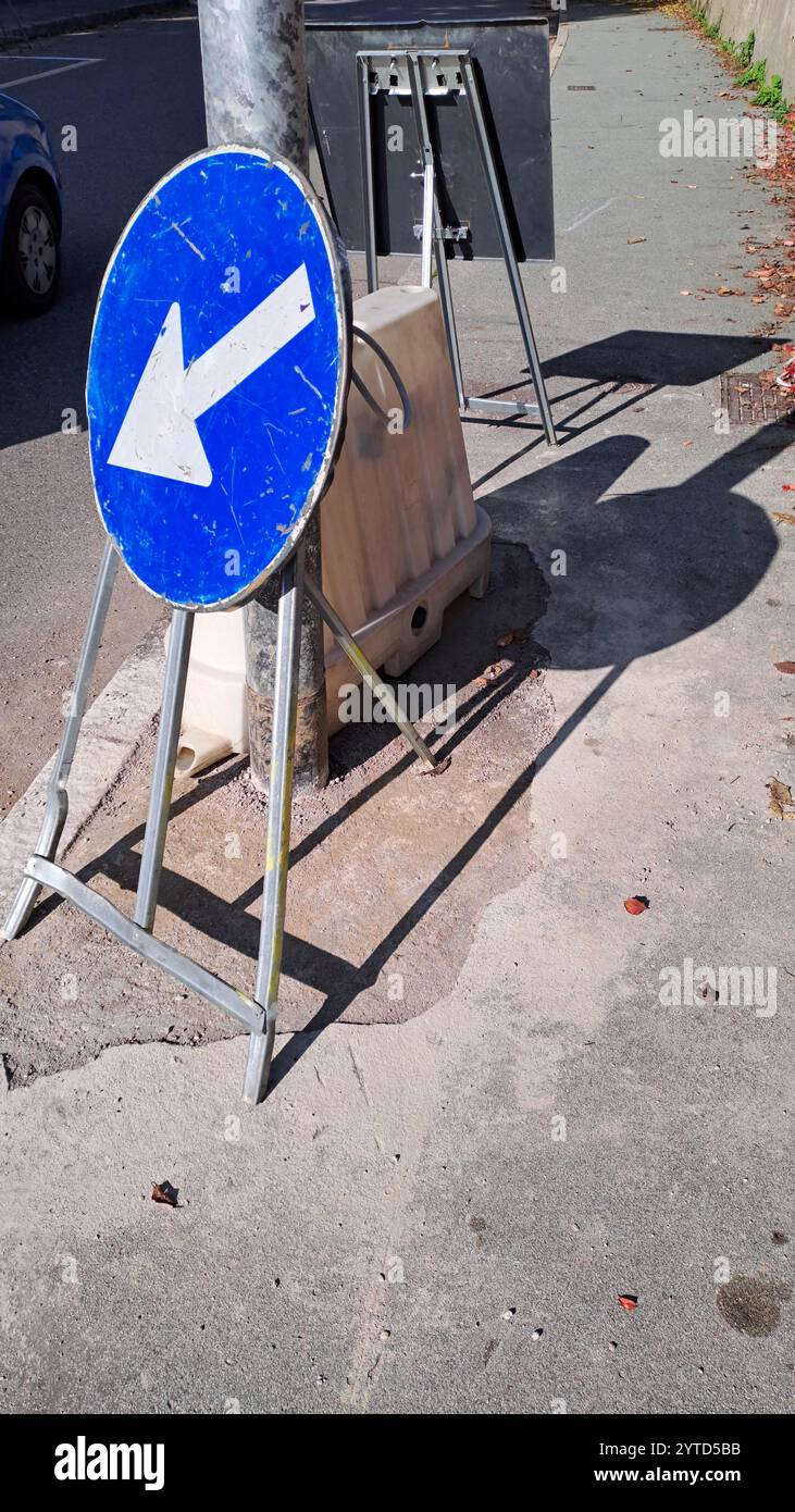 Roadworks Mandatory left turn sign on sidewalk Italy Stock Photo - Alamy
