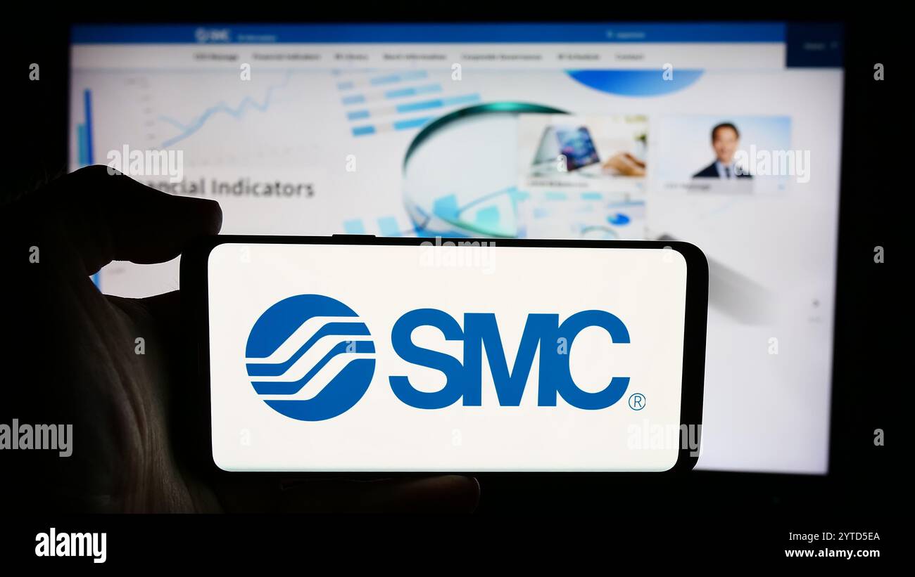 In this photo illustration, a person holds a cellphone with the logo of ...