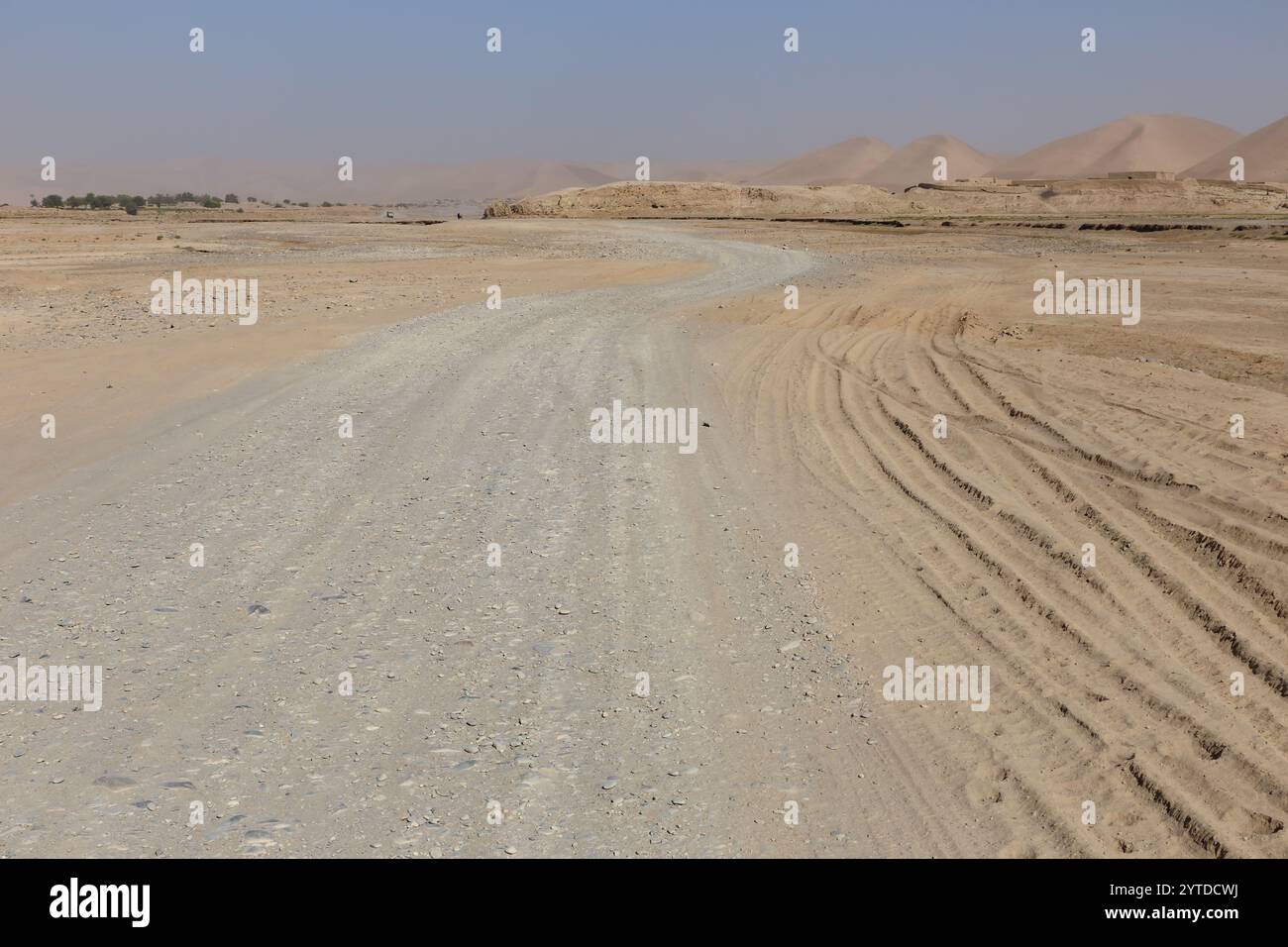 A gravel road winds through Ghurmach's dusty landscape, with distant ...