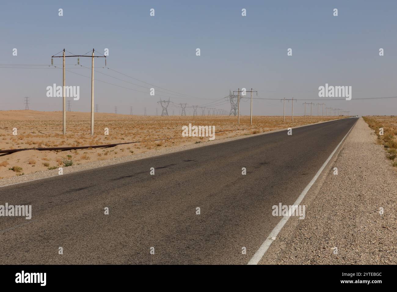A long asphalt road runs through the barren landscape of Jowzjan ...