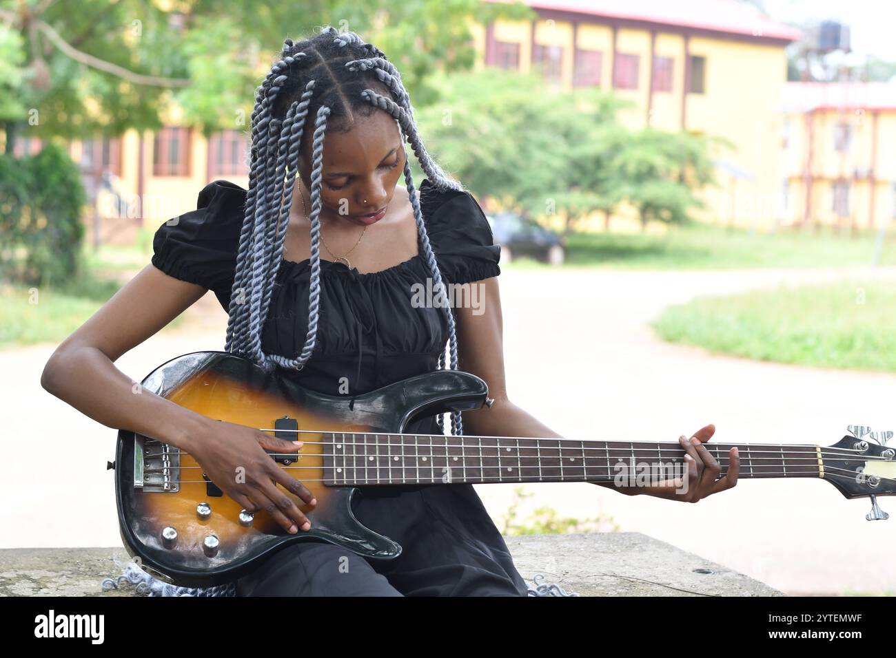 Image of young black african woman playing acoustic guitar outdoor ...