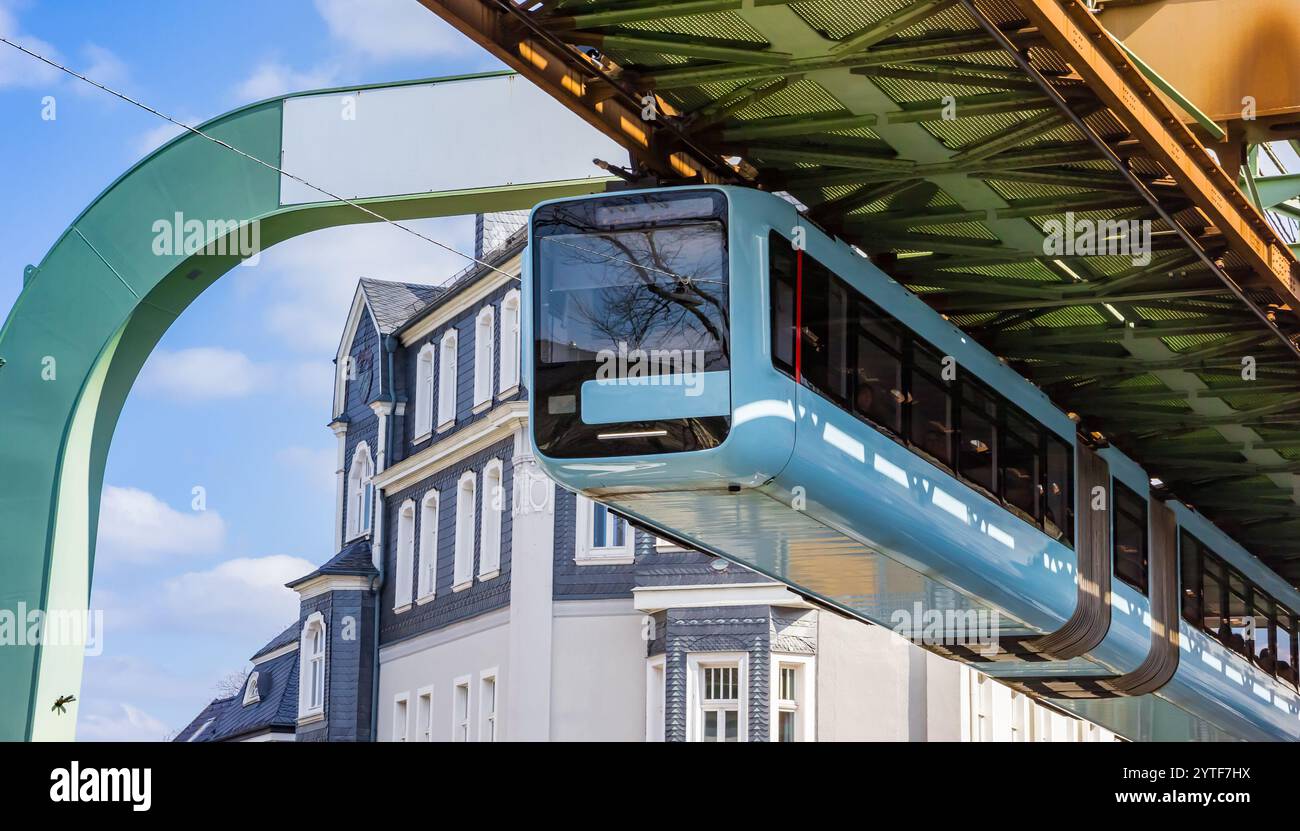 Suspended monorail train in front of a historic house Vohwinkel ...