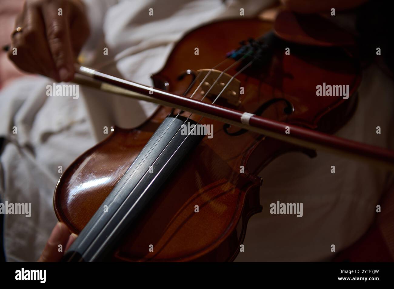 An intimate, detailed view of a musician playing a violin inside ...