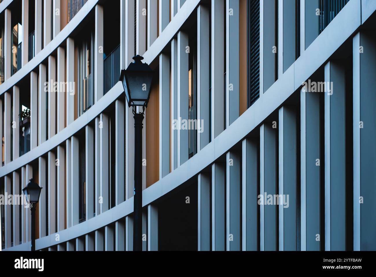 vintage street lamp stands elegantly in front of modern building with ...