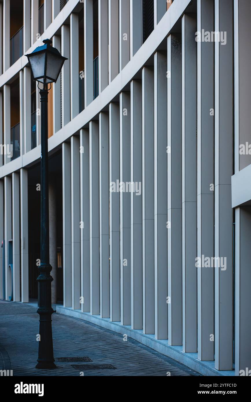 A modern curved building facade featuring rhythmic lines and windows in ...