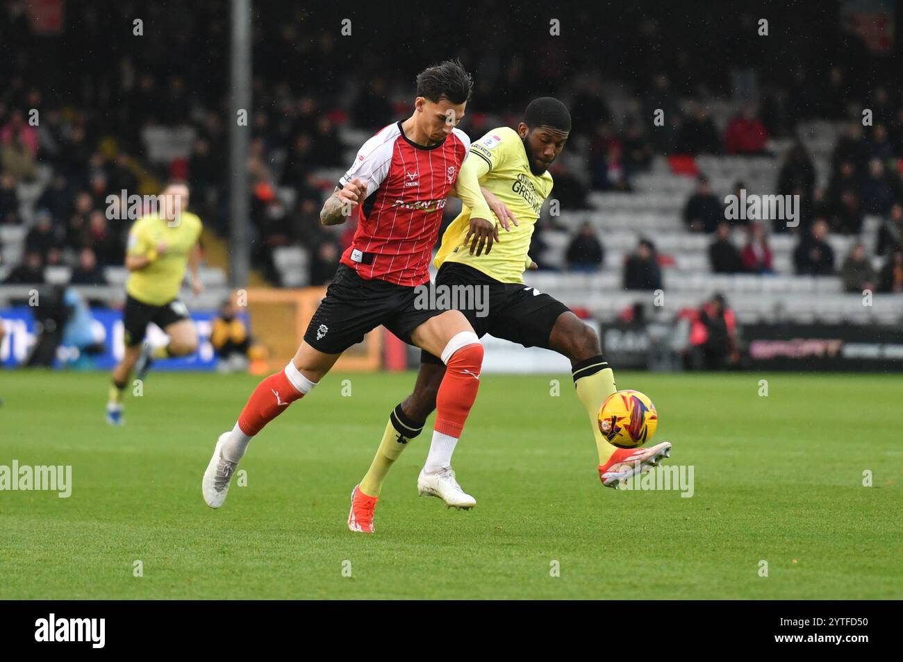 Lincoln, England. 7th Dec 2024. Daniel Kanu and Lewis Monstma during ...