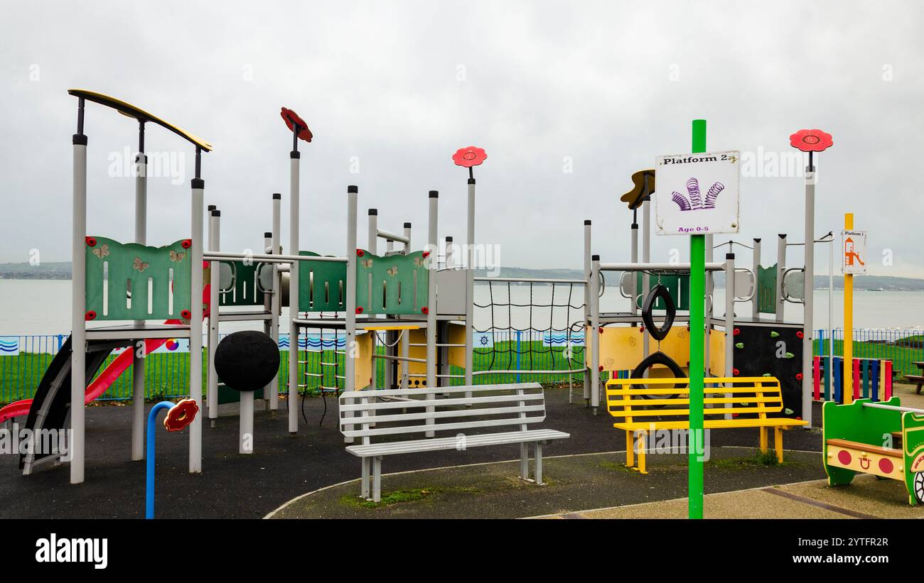 Horizontal climbing frame in a kids playground with benches for the ...