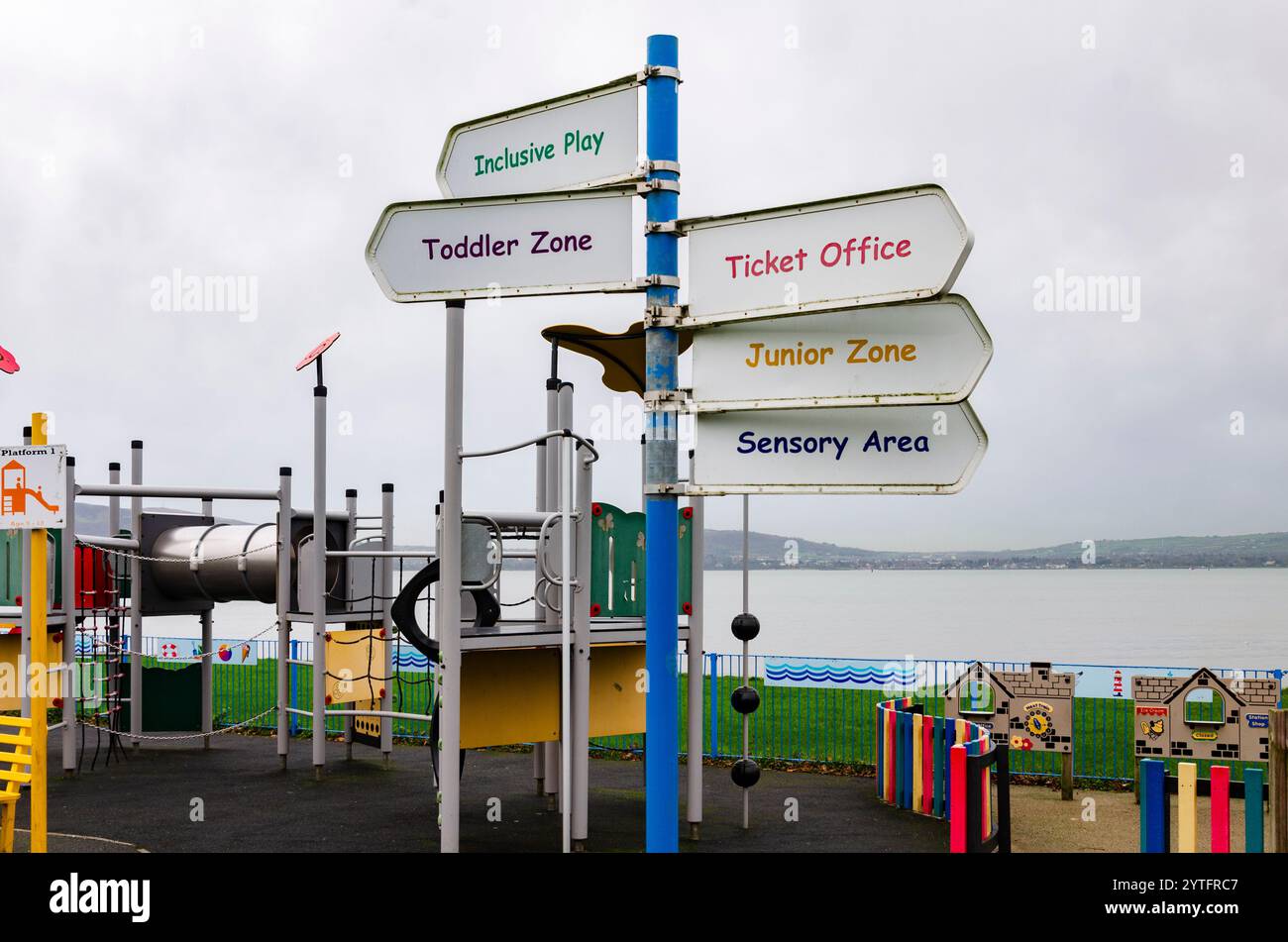 Signpost in a children's playground point to the different areas for ...