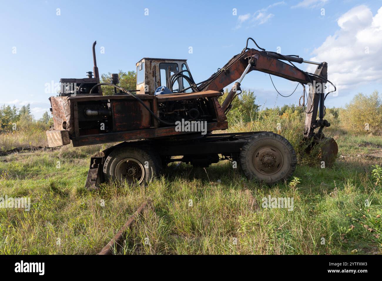 Abandoned Excavator in Overgrown Landscape Stock Photo - Alamy