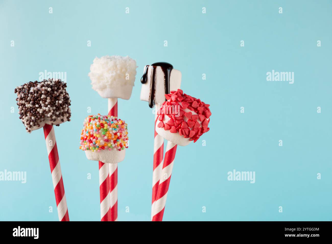 Sweet chewy marshmallow and lollipops on straw decorated with melted ...