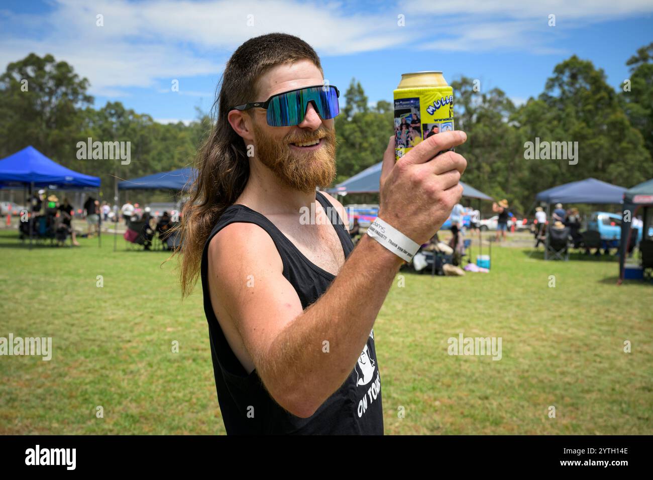 Contestant seen holding a bottle of beer during the Mullet Fest Grand ...