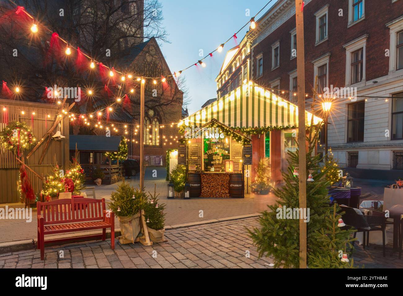 Illuminated Old Riga Christmas market stall with striped green-and ...
