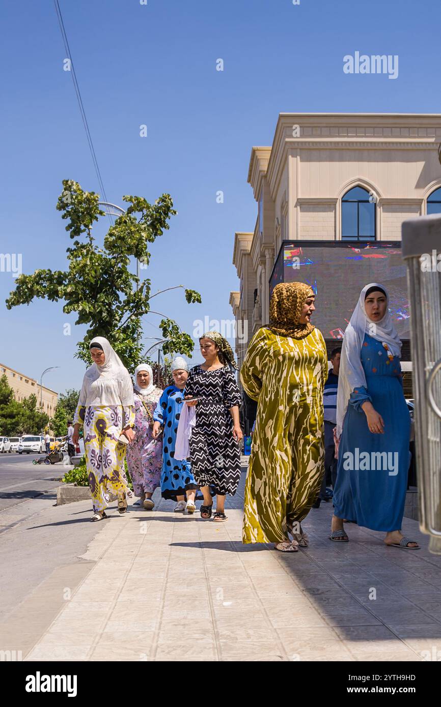 Samarkand, Uzbekistan - 06 July 2024: Women walking in traditional ...