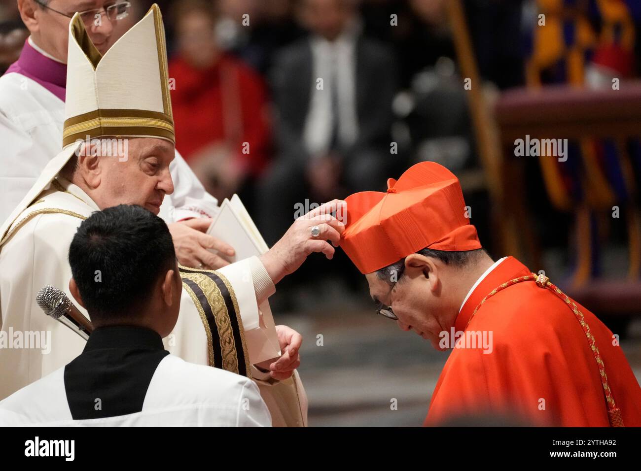 Tarcisio Isao Kikuchi, Archbishop of Tökyõ, Japan, right, receives from ...