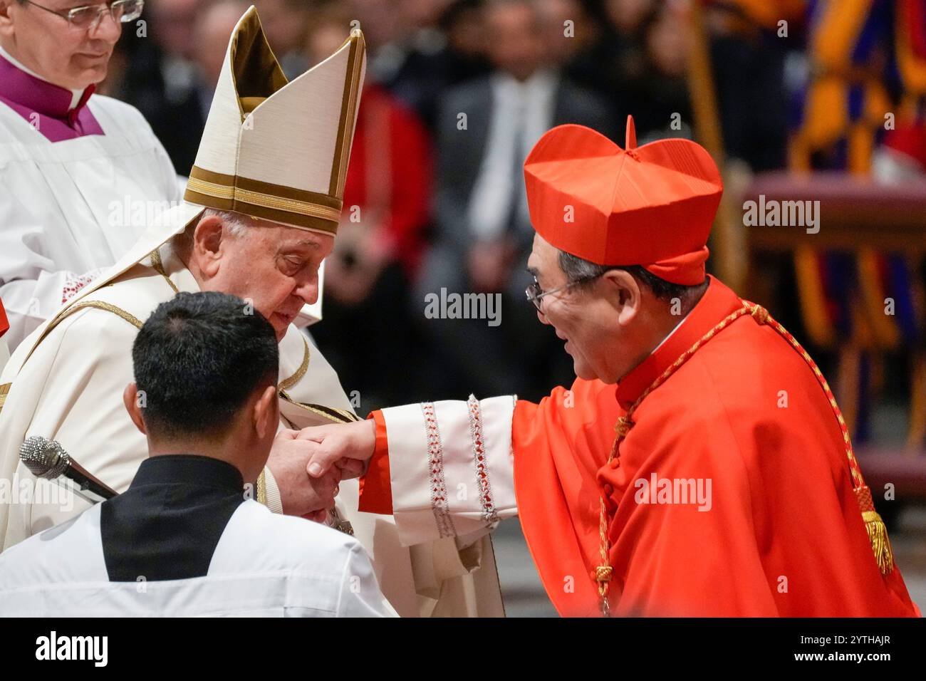 Tarcisio Isao Kikuchi, Archbishop of Tökyõ, Japan, right, receives from ...