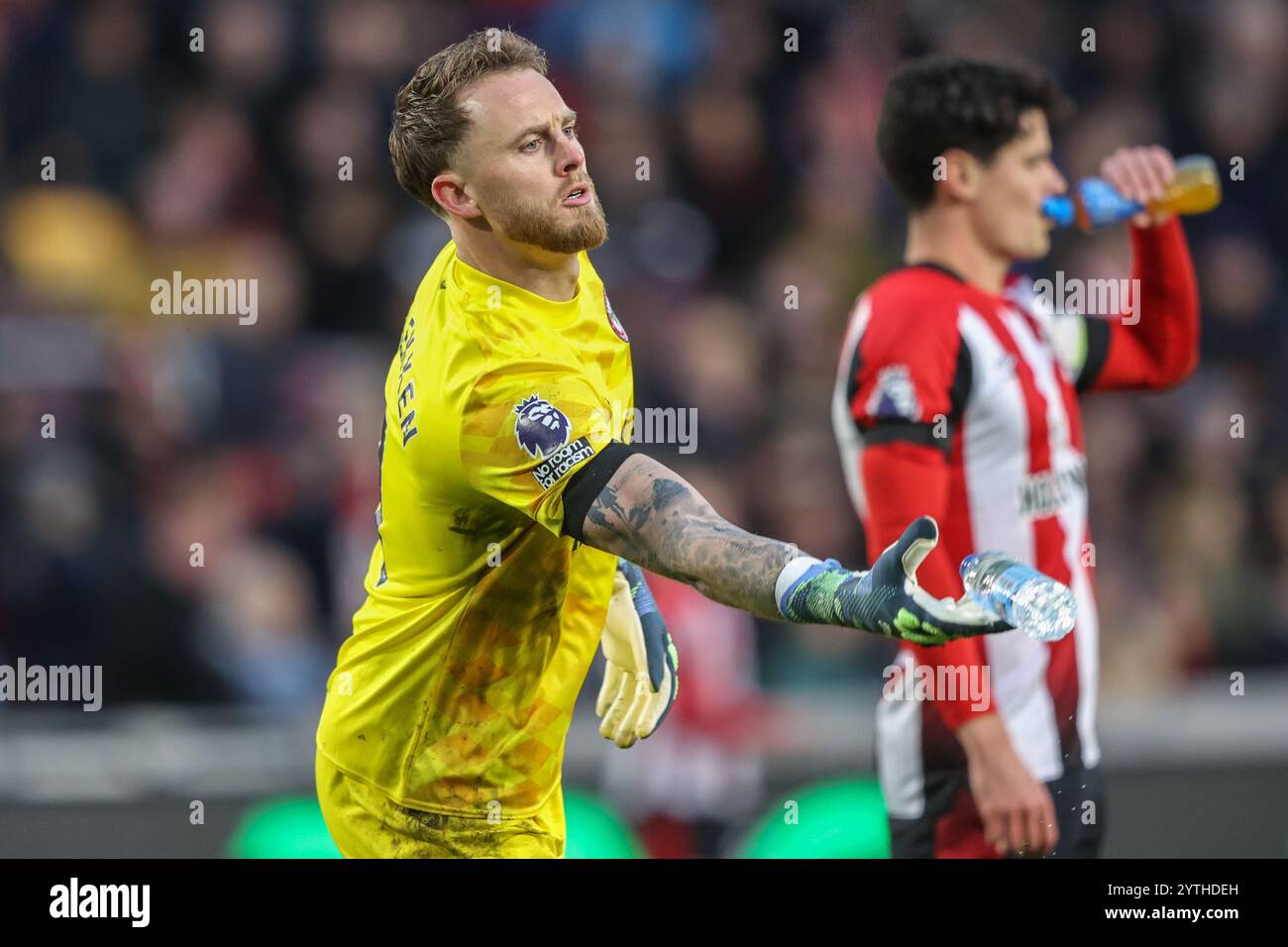 Mark Flekken of Brentford throws a bottle of water to his teammate ...