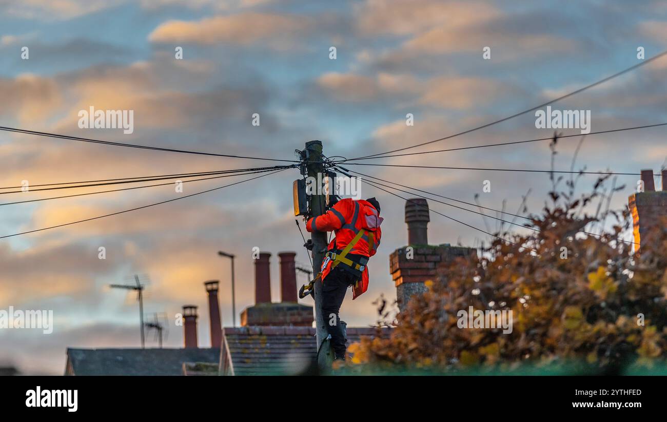 BT Engineer up a telephone pole on Garrick rd connecting fibre ...