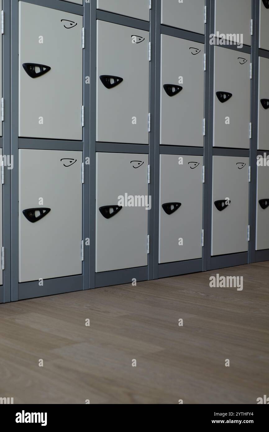 Section of a bank of grey lockers with copy space in lower third over ...