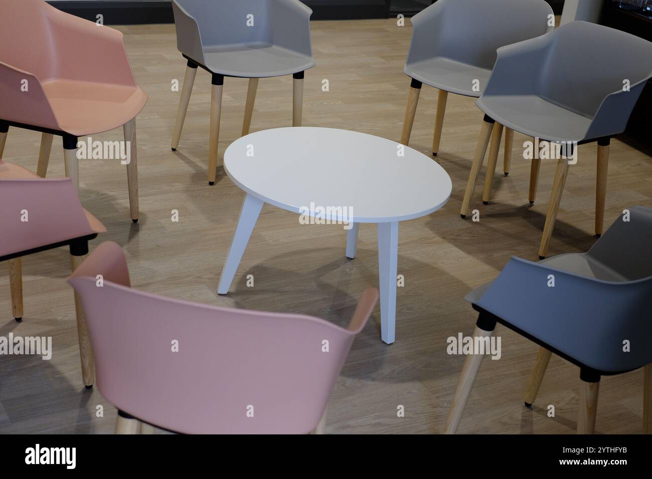 Empty chairs surrounding a small table ready for a coffee break in a ...