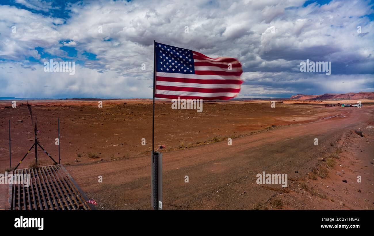 MARCH 2024, TONALEA ARIZONA - Navajo Tribal Highway, US torn flag flies ...