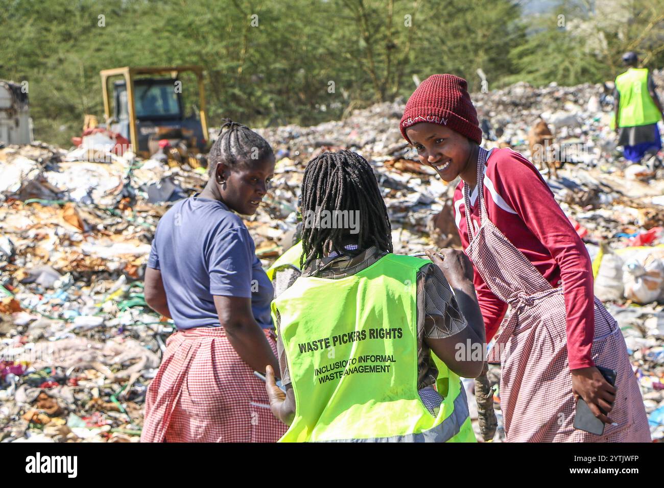 Women waste pickers are seen talking at Gioto dumpsite. Negotiations to ...