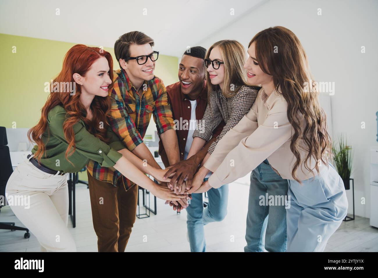 Portrait of five young successful colleagues pile stack handshake ...