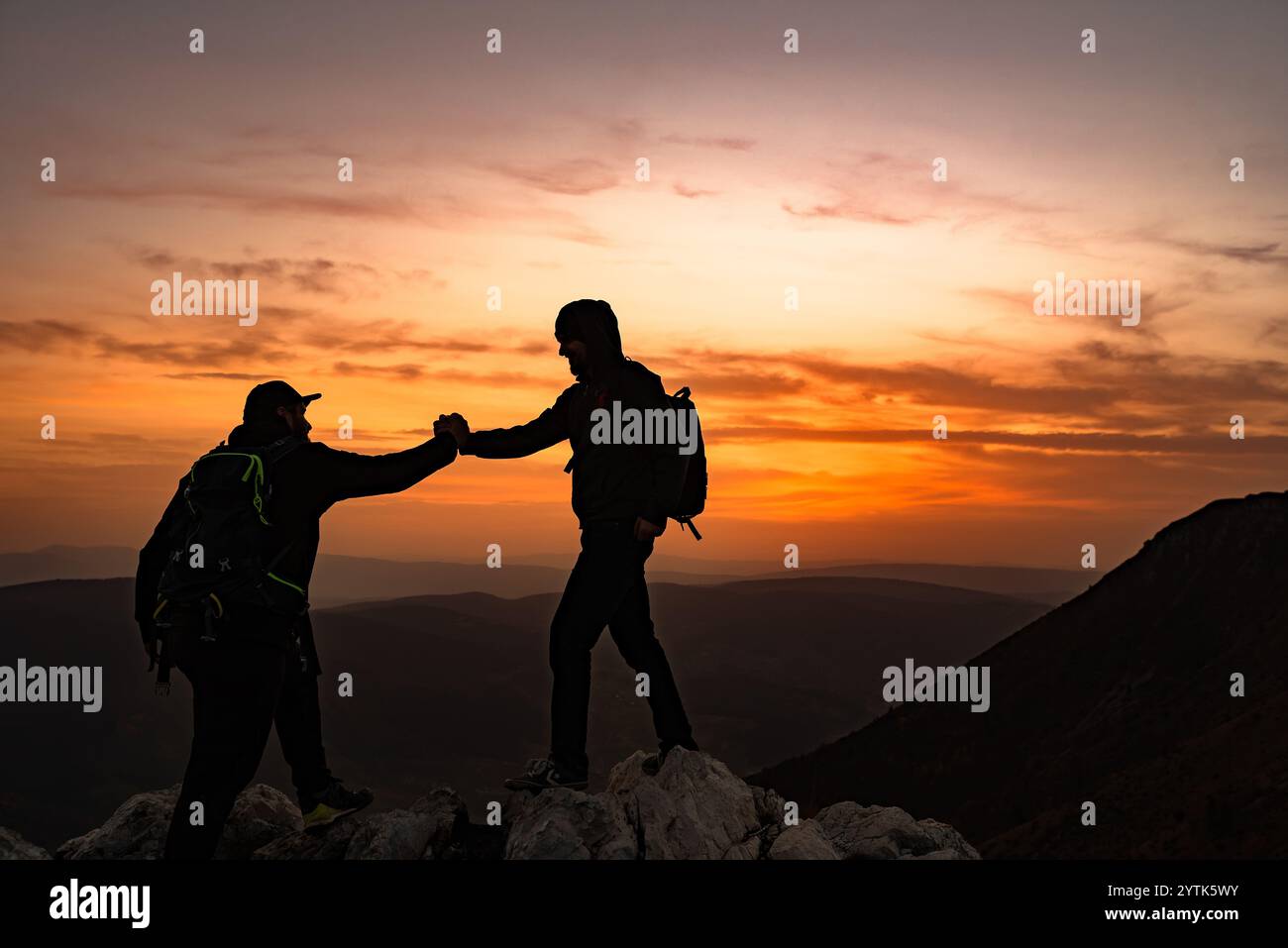 Hiking team people helping each other friend giving a helping hand ...